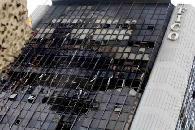 Hot spots inside burnt high-rise hosed down