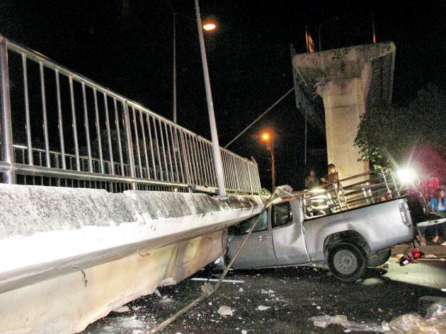 Trailer brings down part of bridge