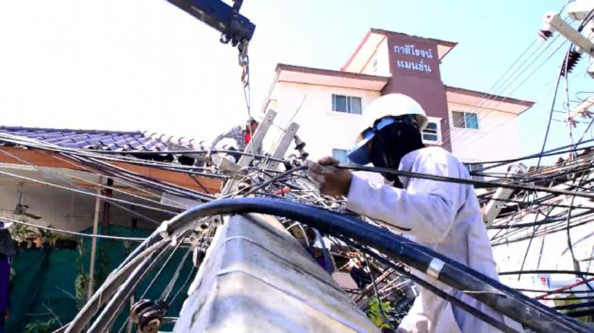 Fallen power poles crash onto homes, cars